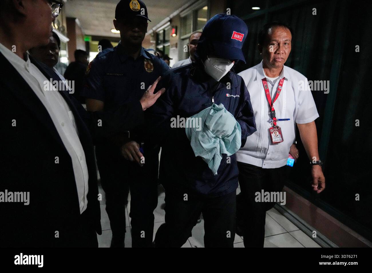 Police escort the initial batch of arrested suspects in a major ...