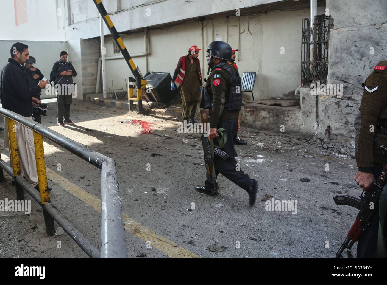 Security officials examine the site of a suicide bombing attack at the ...