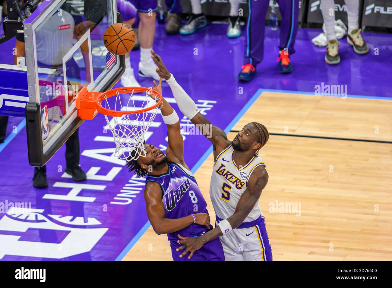 Utah Jazz guard Isaiah Collier (8) lays the ball off the glass defended ...
