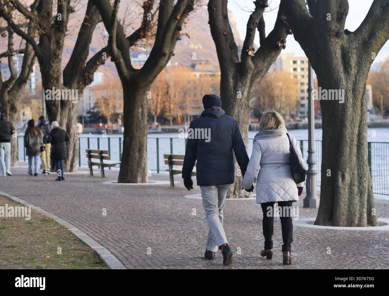 Lecco's lakeside promenade in November, late in the afternoon, is a ...