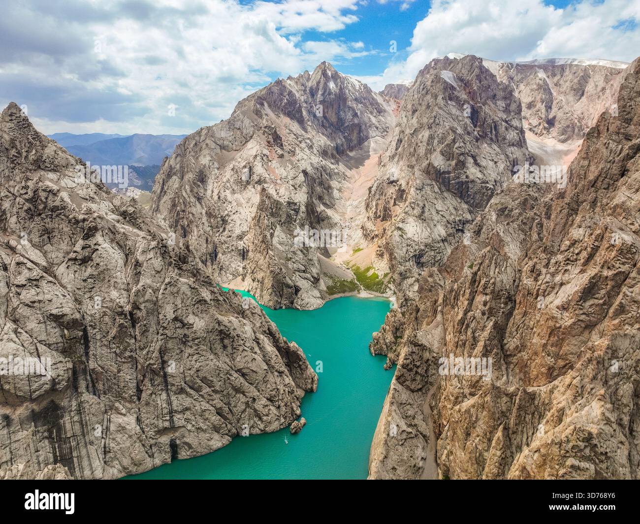 Wide, dramatic aerial view of a vibrant turquoise lake winding through ...