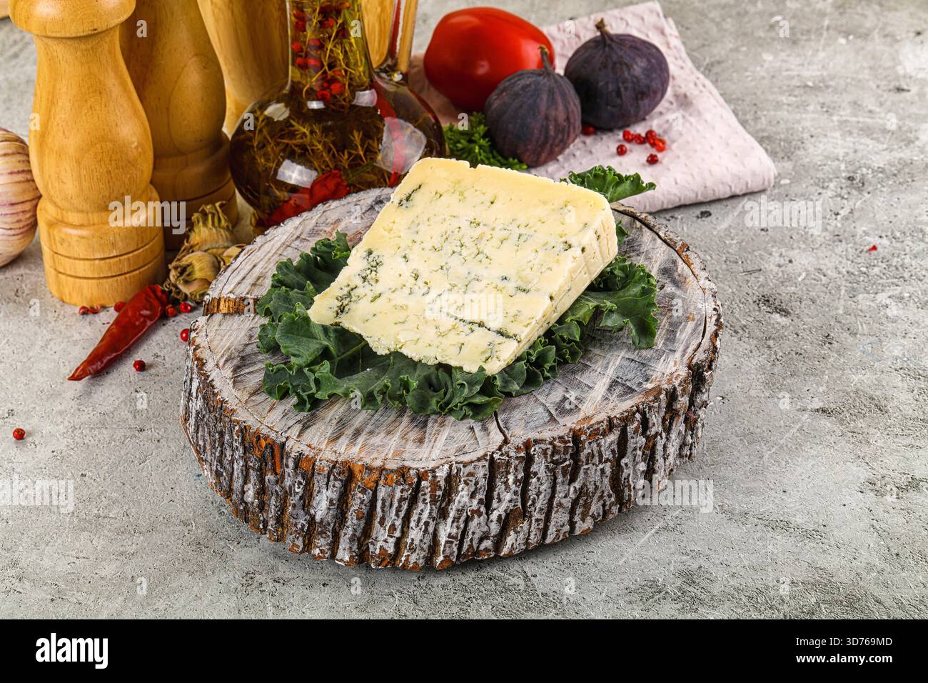 Blue cheese piece over board served fig Stock Photo - Alamy