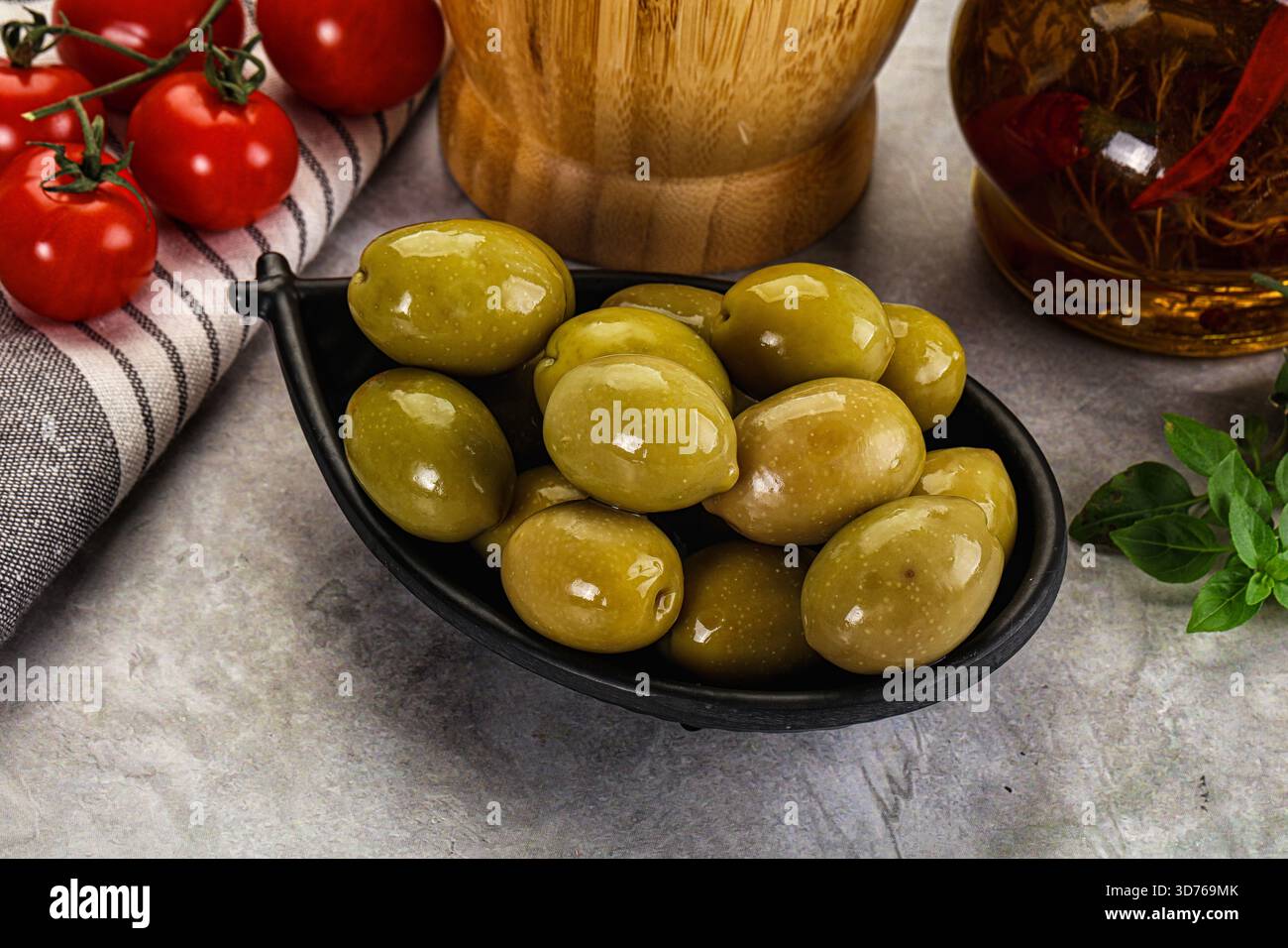 Big ripe green marinated olives in the bowl Stock Photo - Alamy