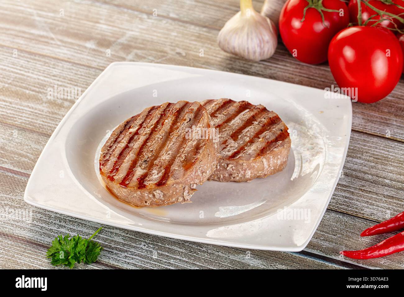 Grilled tuna steak fillet round medallion Stock Photo - Alamy
