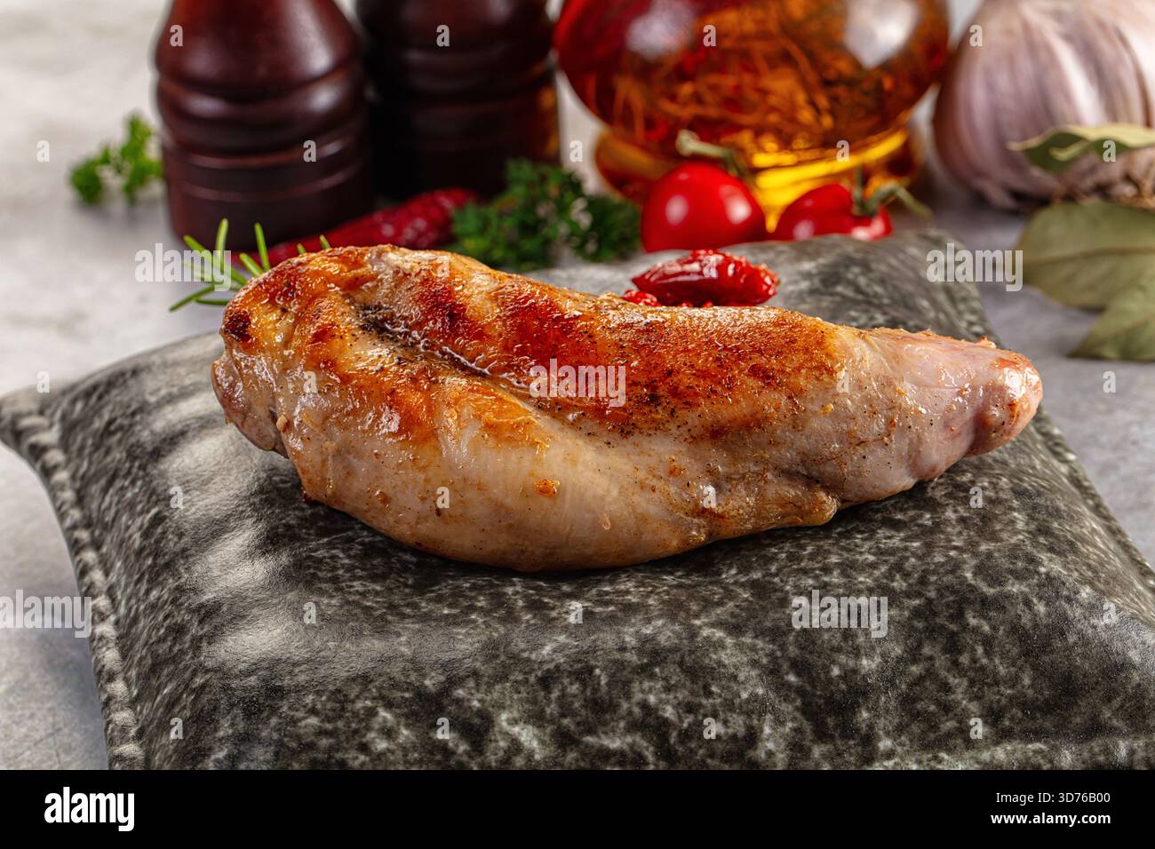 Roasted rabbit leg served rosemary in the plate Stock Photo - Alamy