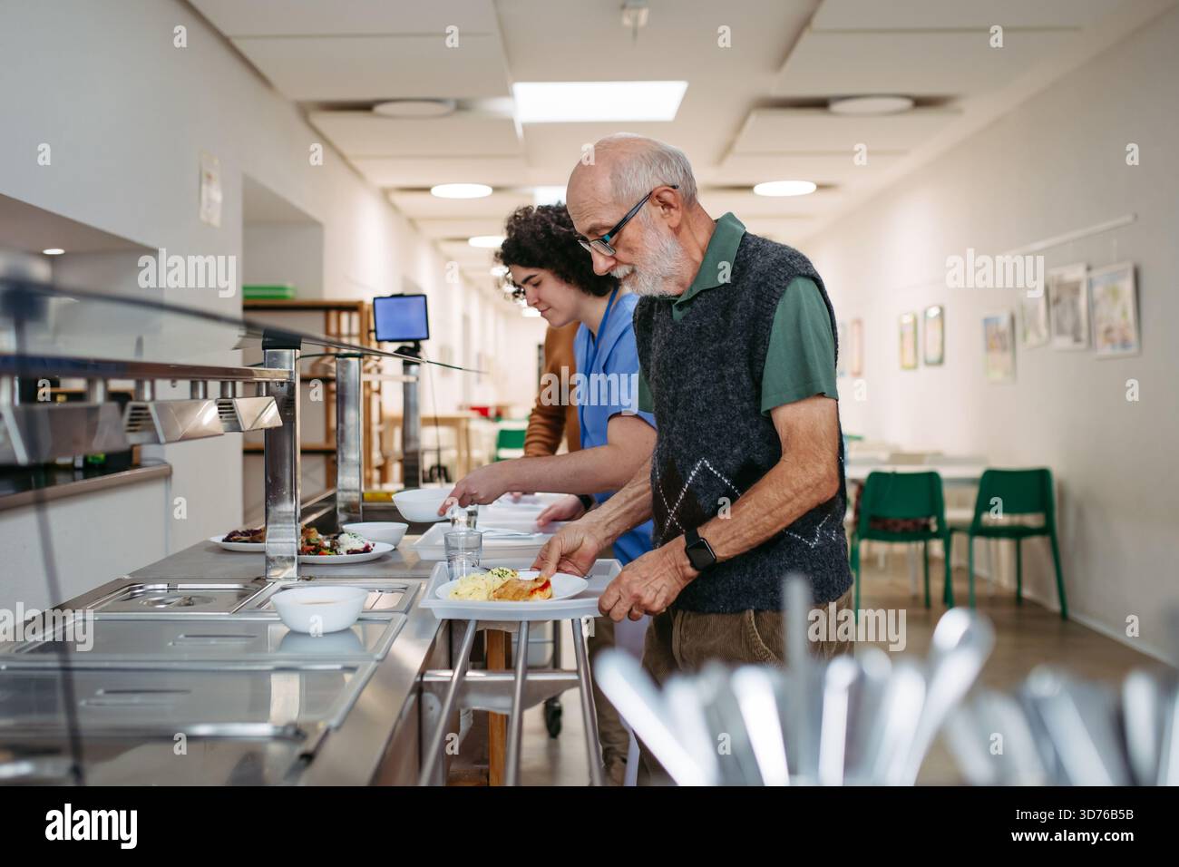 Group of seniors having lunch in community center cafeteria Stock Photo ...