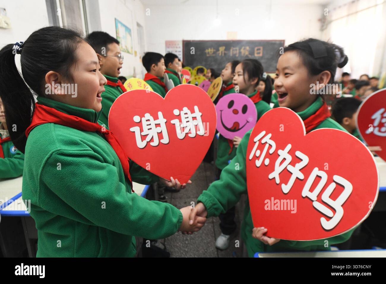Pupils show greetings cards they made to celebrate the World Hello Day ...