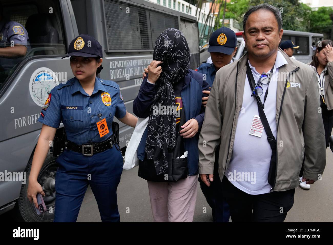 Police escort a suspect, center, in a major corruption scandal ...