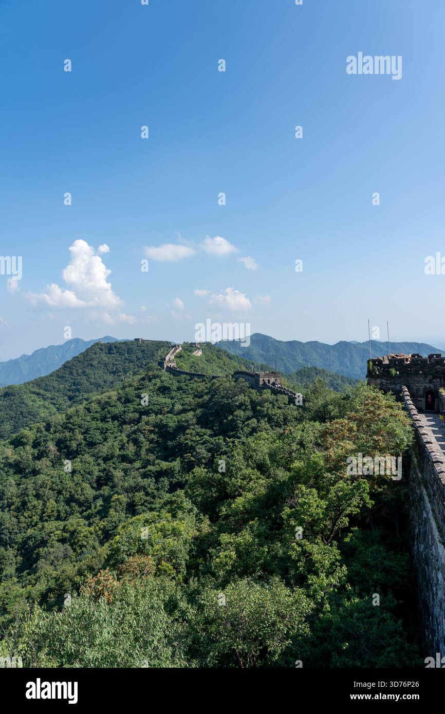 A section of the Great Wall runs alongside foreground foliage and a ...