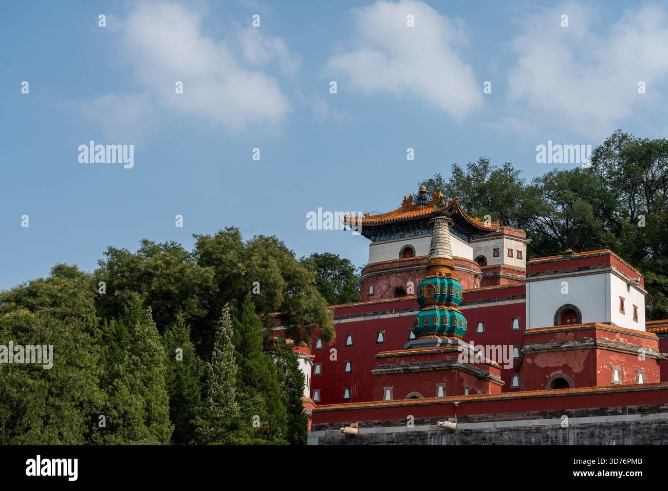 A complex of red Chinese walls and white buildings surrounds a central ...