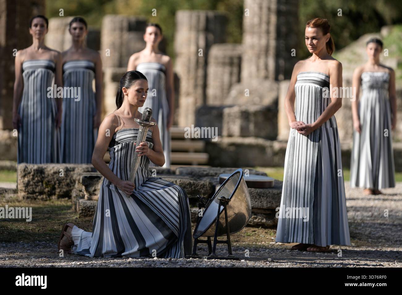 Actor Mary Mina playing the role of high priestess, left, performs ...