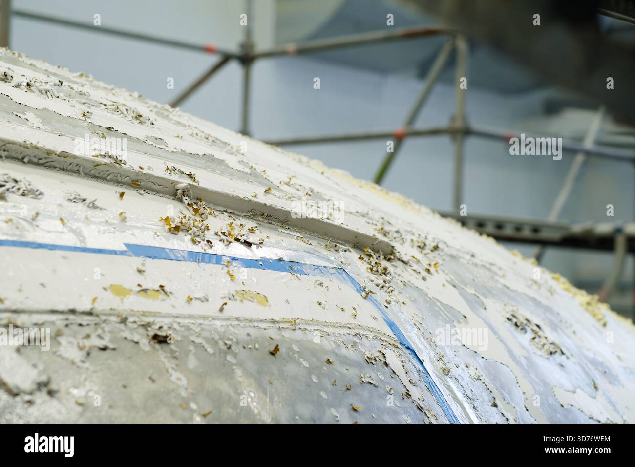 Close up view of a spacecraft surface being restored in a workshop ...