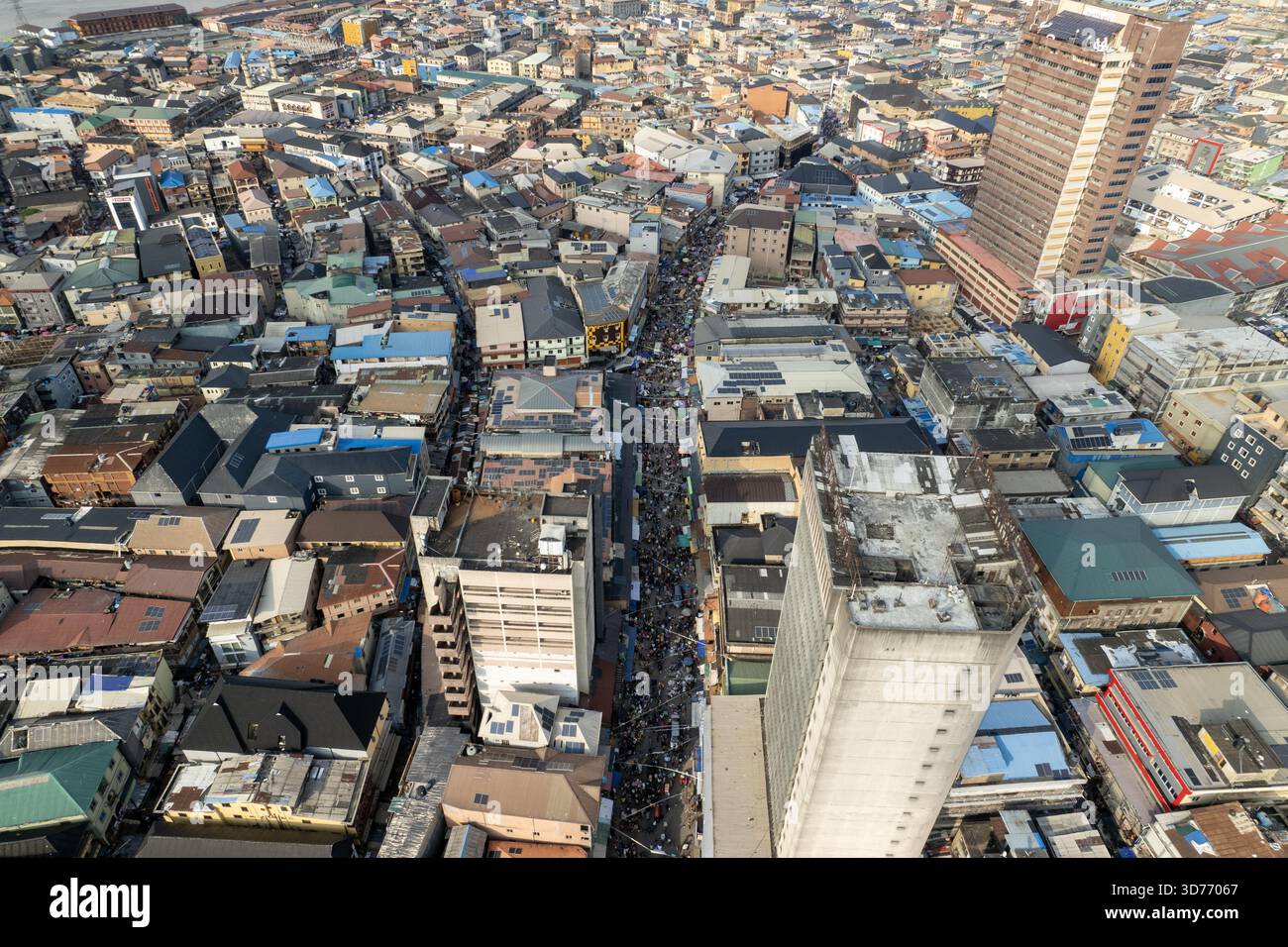 Aerial view of densely packed buildings and a narrow street teeming ...