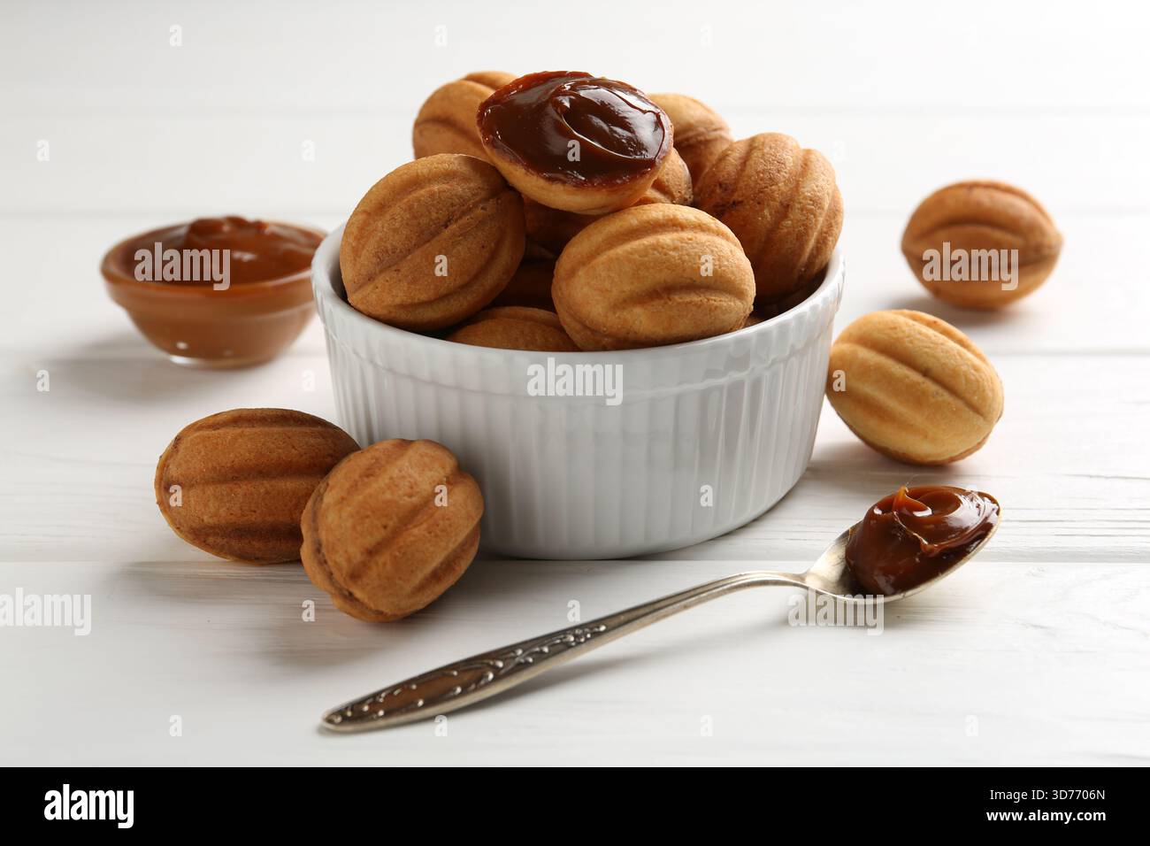 Delicious nut shaped cookies with boiled condensed milk and spoon on ...