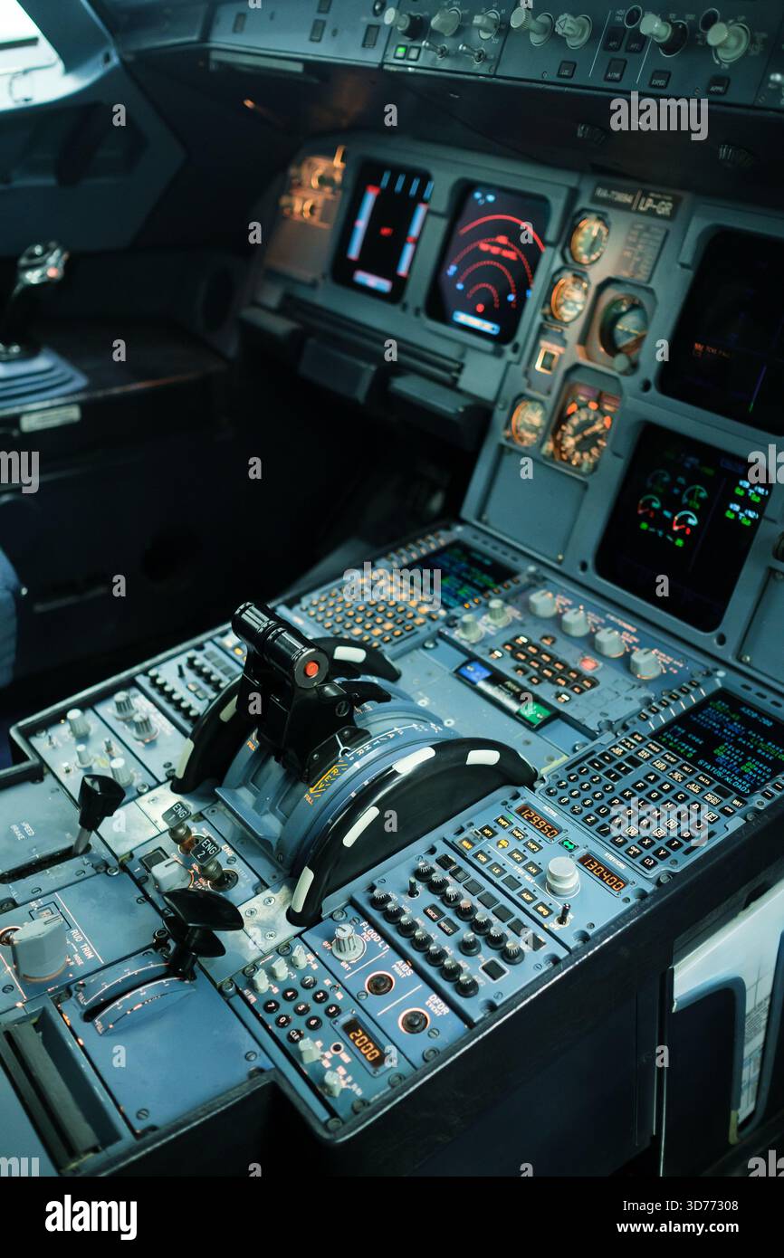 Inside a well-equipped airplane cockpit, the control panel displays ...
