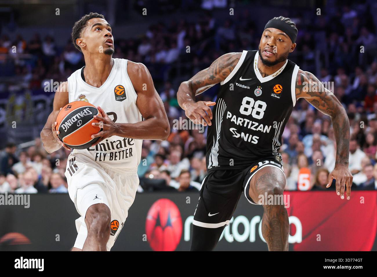 Theo Maledon of Real Madrid and Tyrique Jones of Partizan during the ...