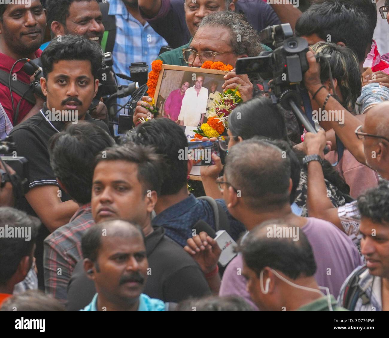 A fan holds the photograph of Bollywood actor Dharmendra during his ...