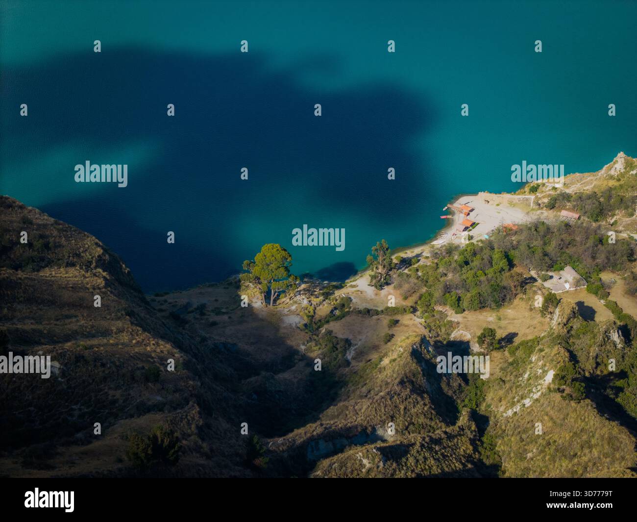 Aerial view of the turquoise lake water meeting the rugged cliffs, a ...