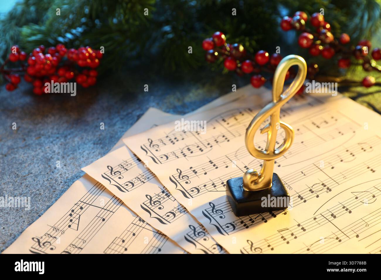 Golden treble clef, music sheets and Christmas decor on gray textured ...