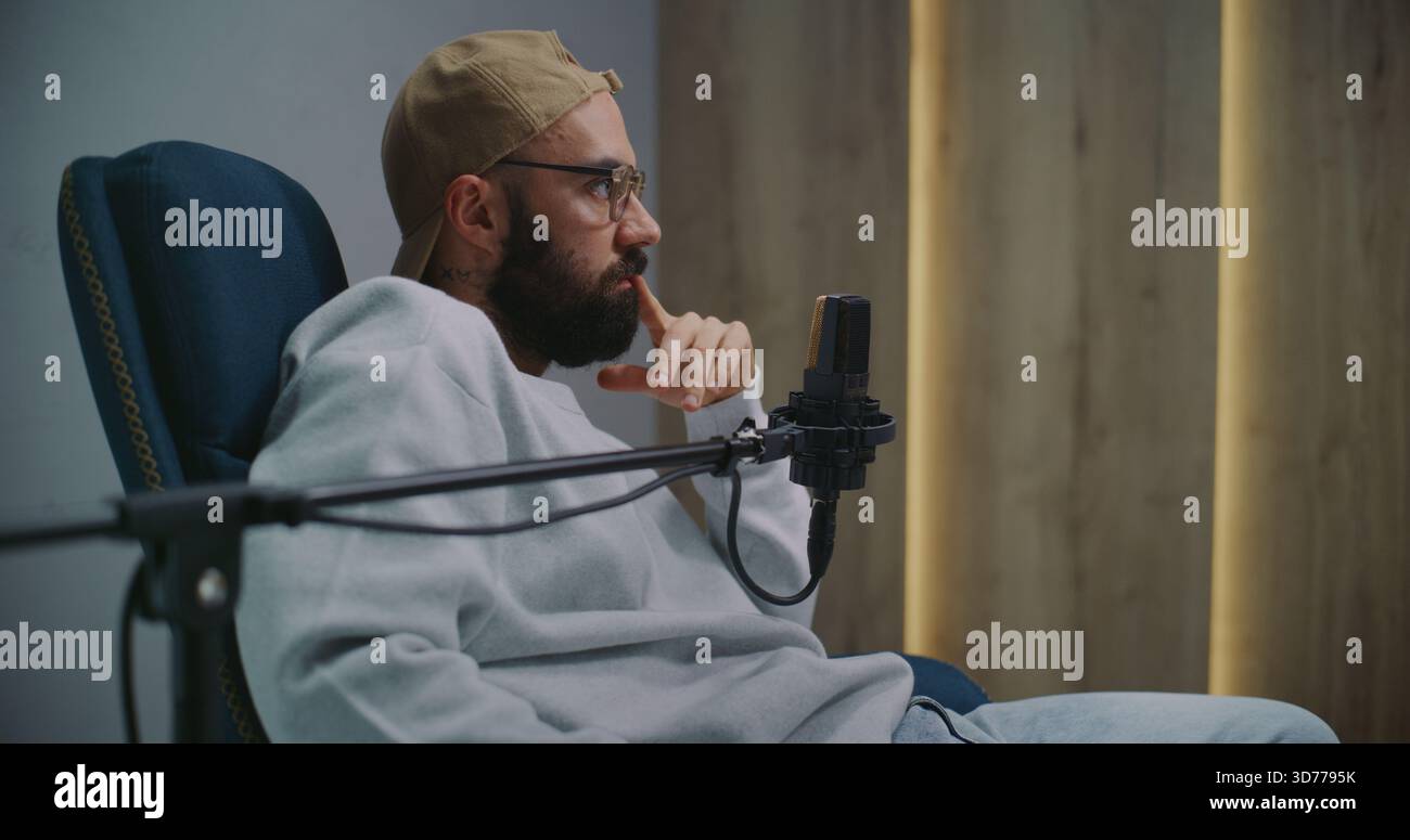 Bearded podcast host in cap hi-res stock photography and images - Alamy