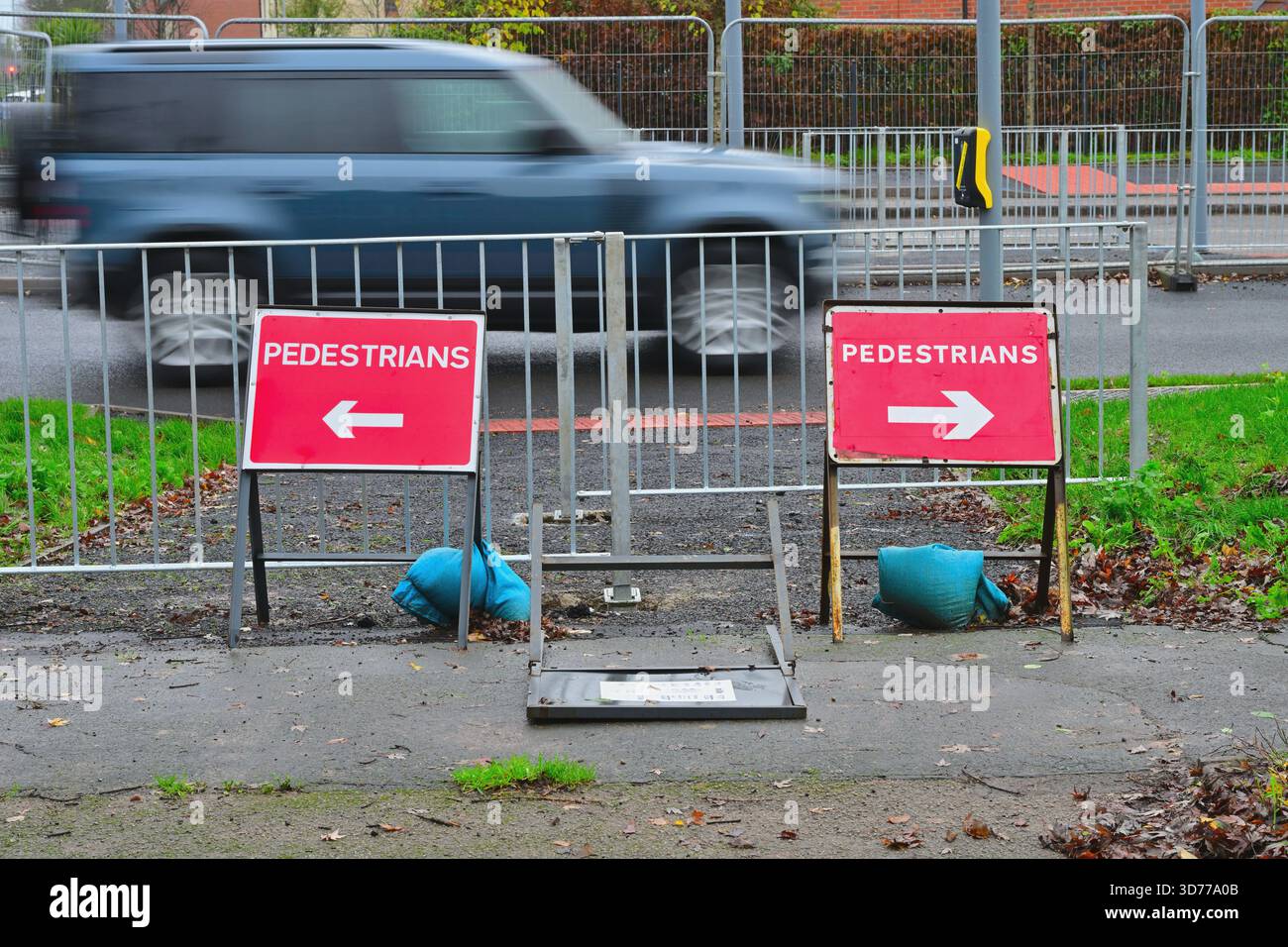 Confusing Pedestrian Signs with Barricades on Wet Urban Roadside Stock ...