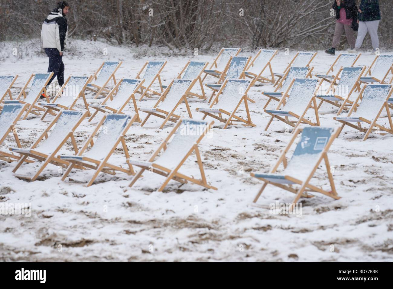 Beach chairs covered in snow are seen ahead of a cold water swimming ...