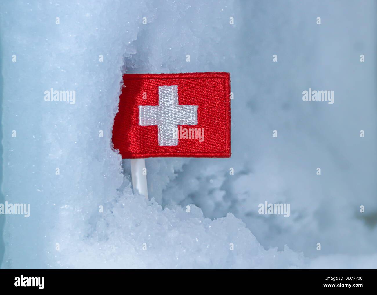 Swiss embroidered flag patch set in glacial Alpine snow, evoking winter ...