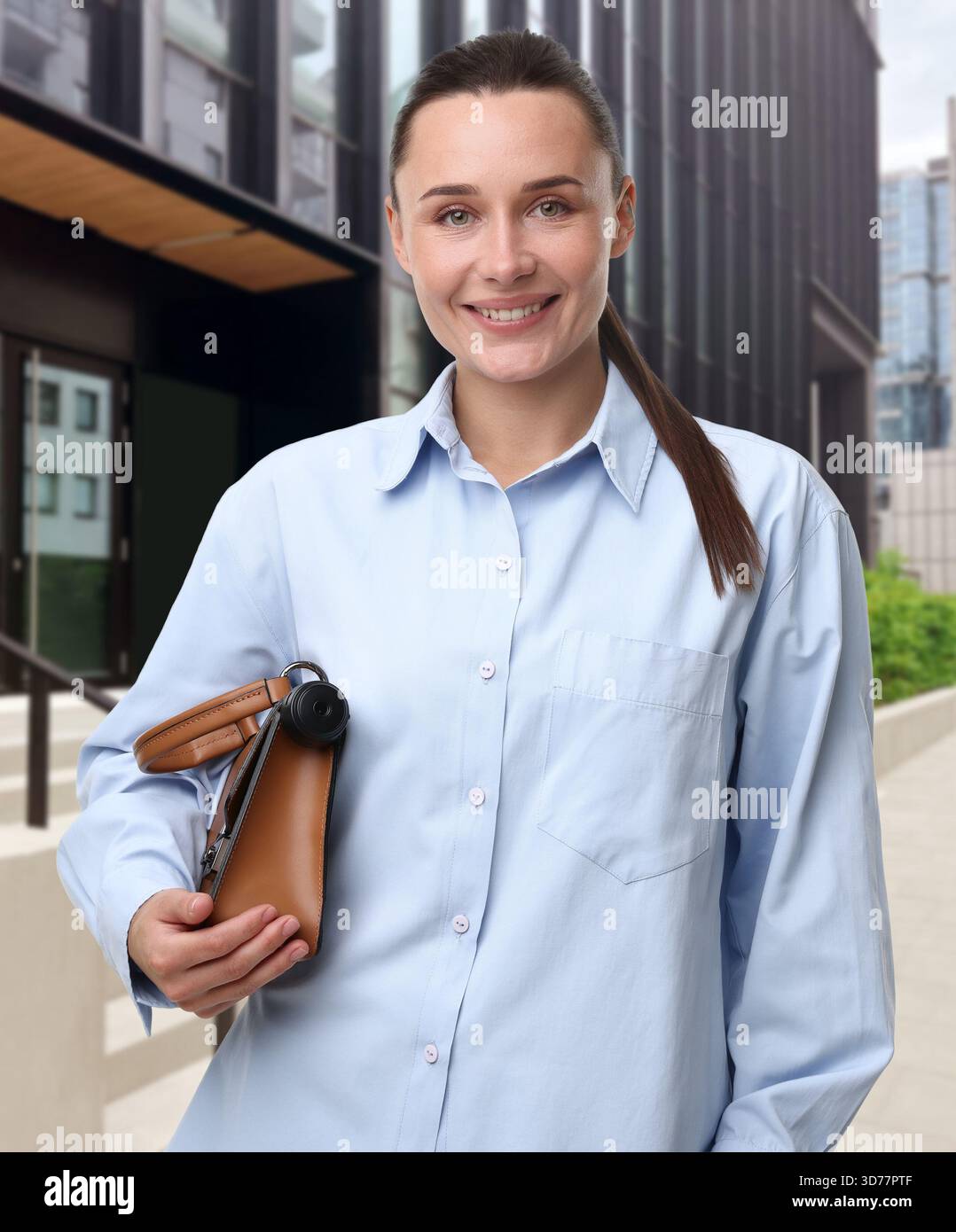 Woman with hidden spy camera on her bag near building outdoors Stock ...