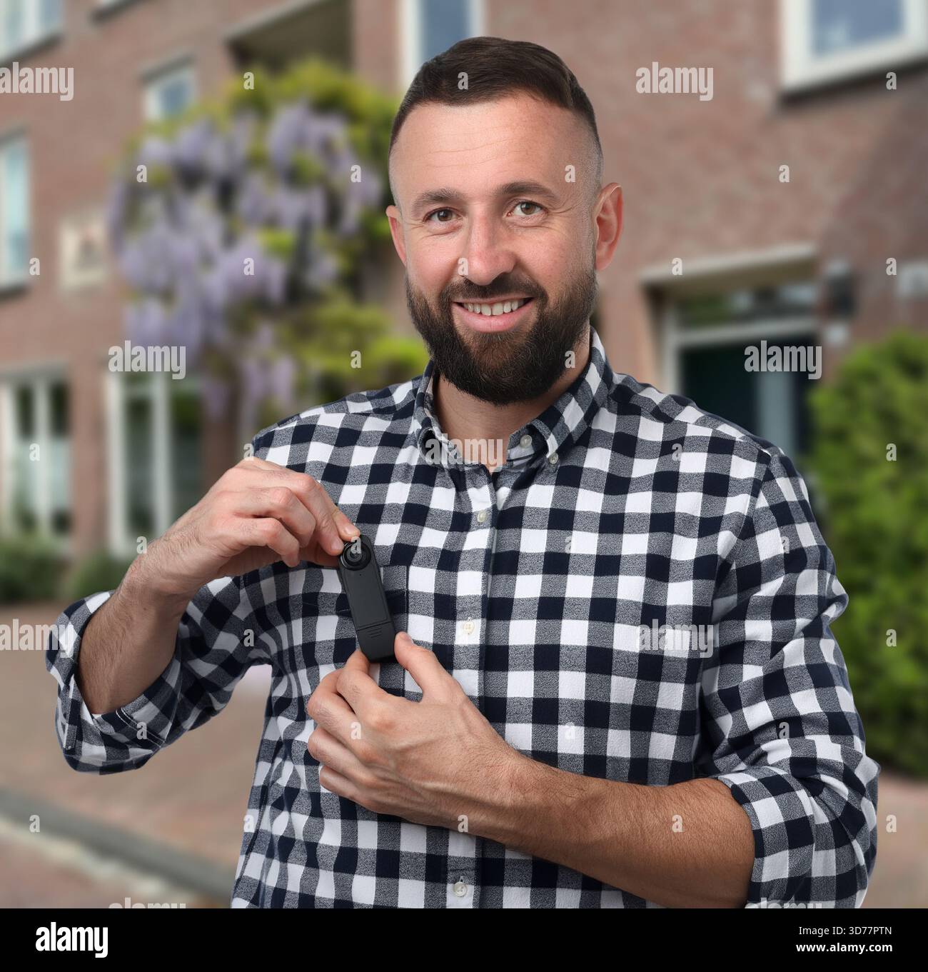 Man with hidden spy camera near building outdoors Stock Photo - Alamy