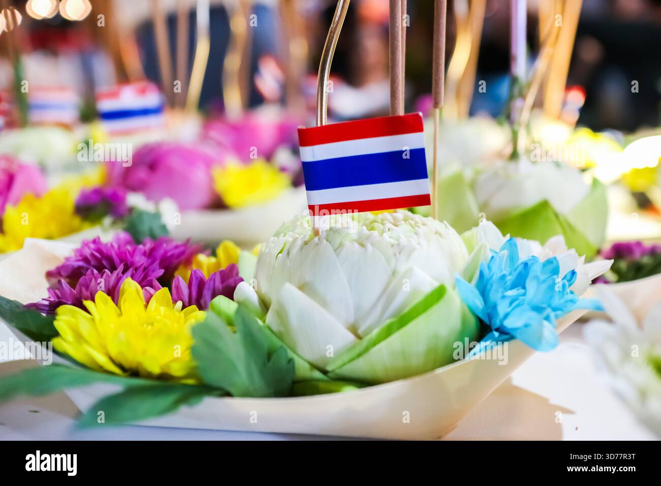 Thai flag placed on a natural lotus Krathong with folded white lotus ...