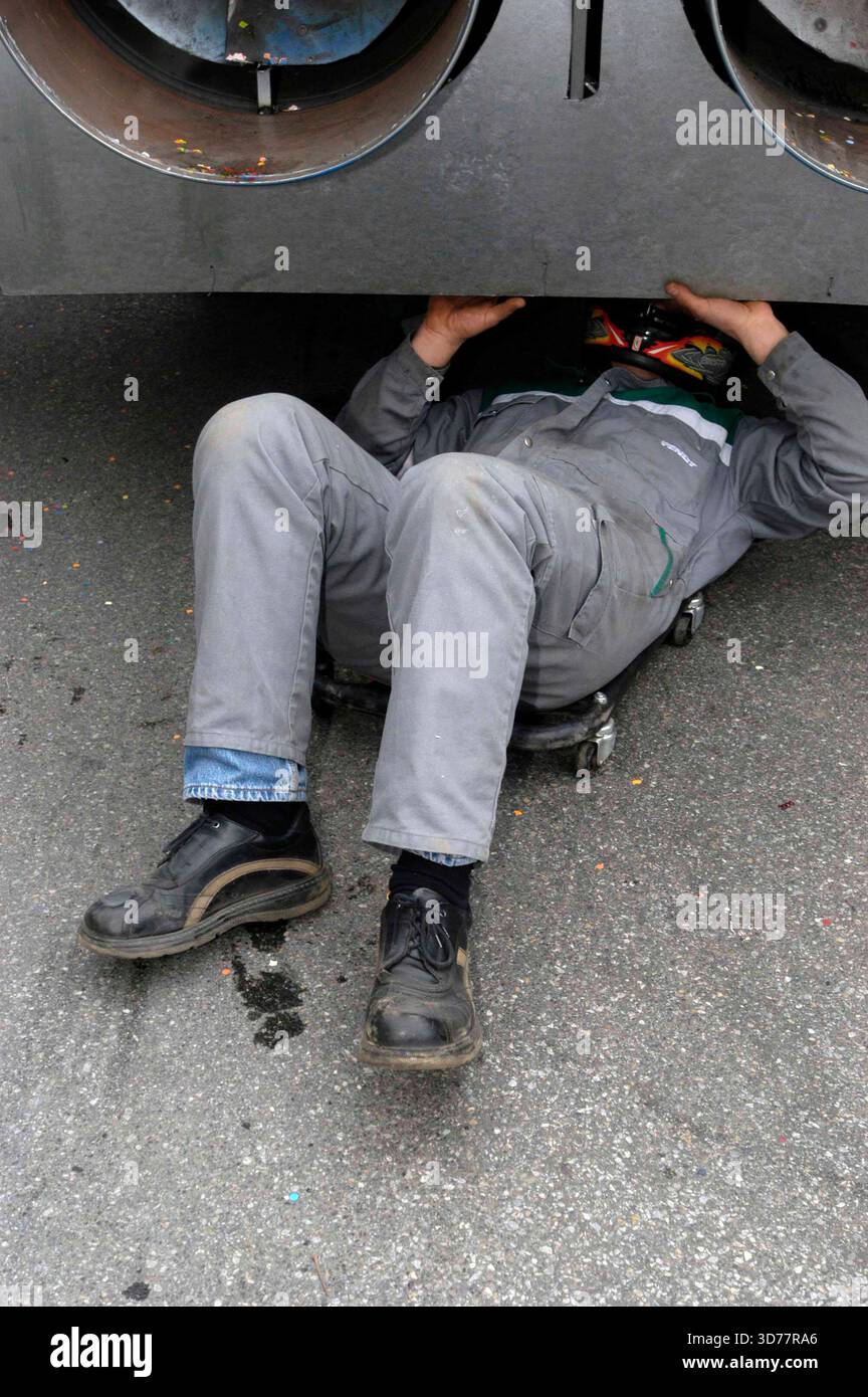 automotive mechanic works on the car to fix a problem automotive ...