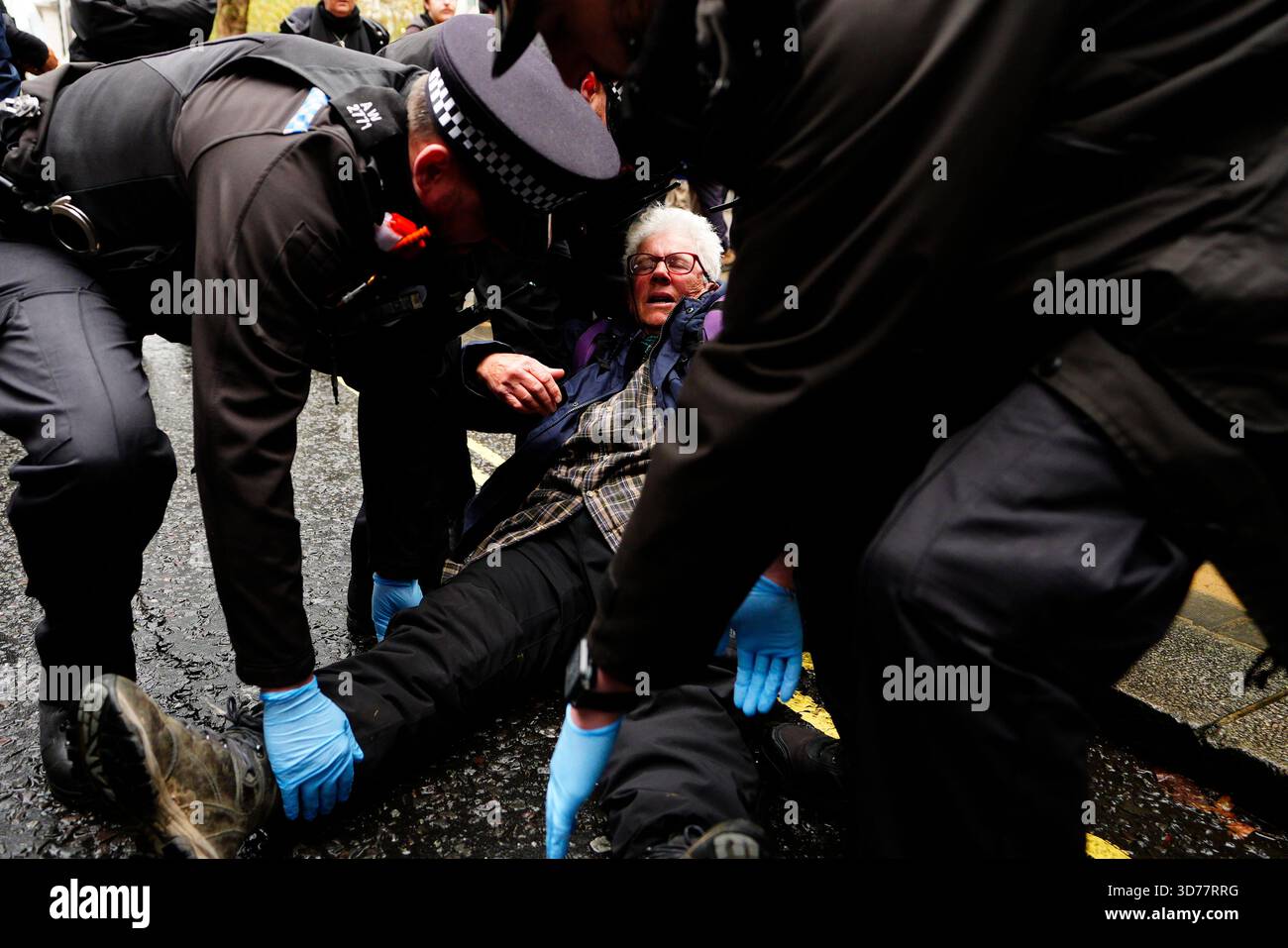 Police remove a campaigner taking part in a Defend Our Juries protest ...