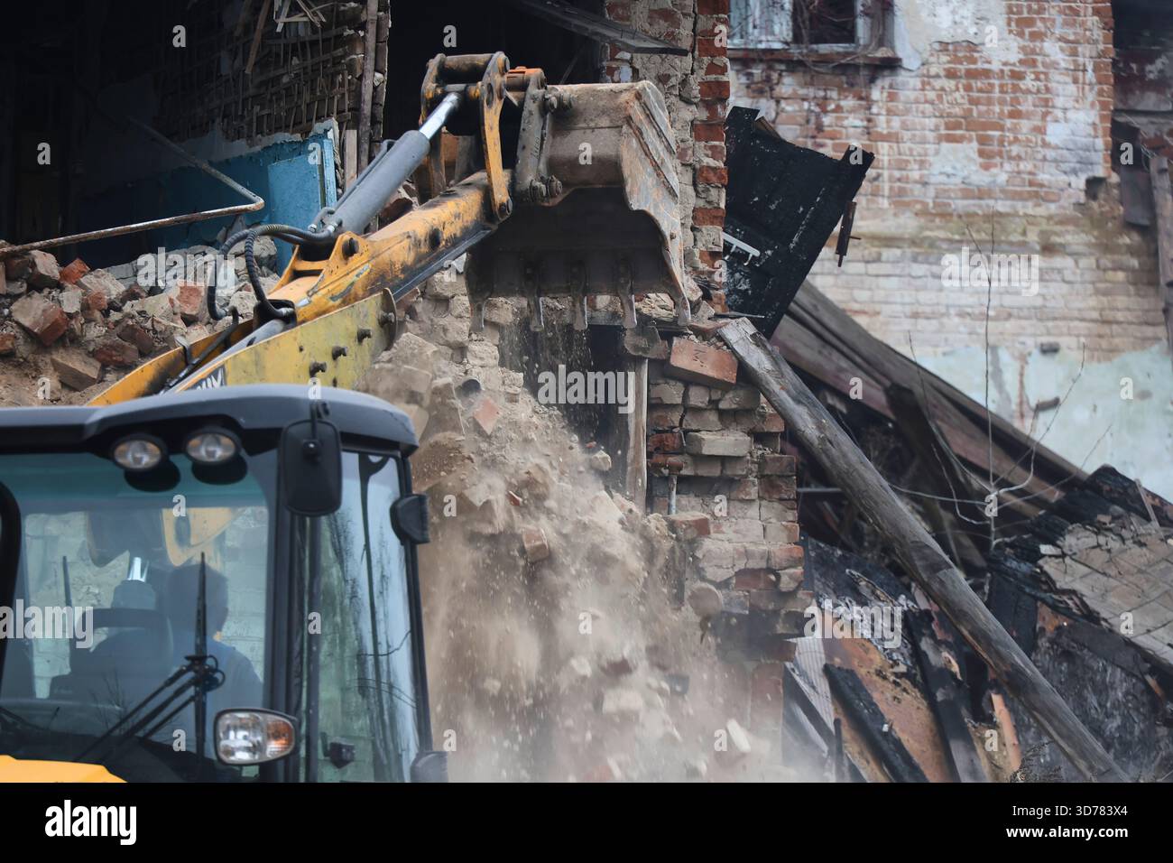 Municipal workers dismantle a historic building destroyed by a Russian ...
