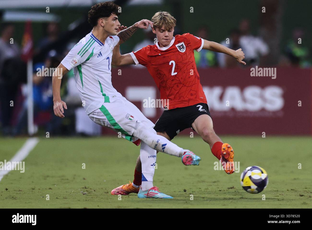 Italy's Andrea Luongo, left, kicks the ball next to Austria's Rafael ...