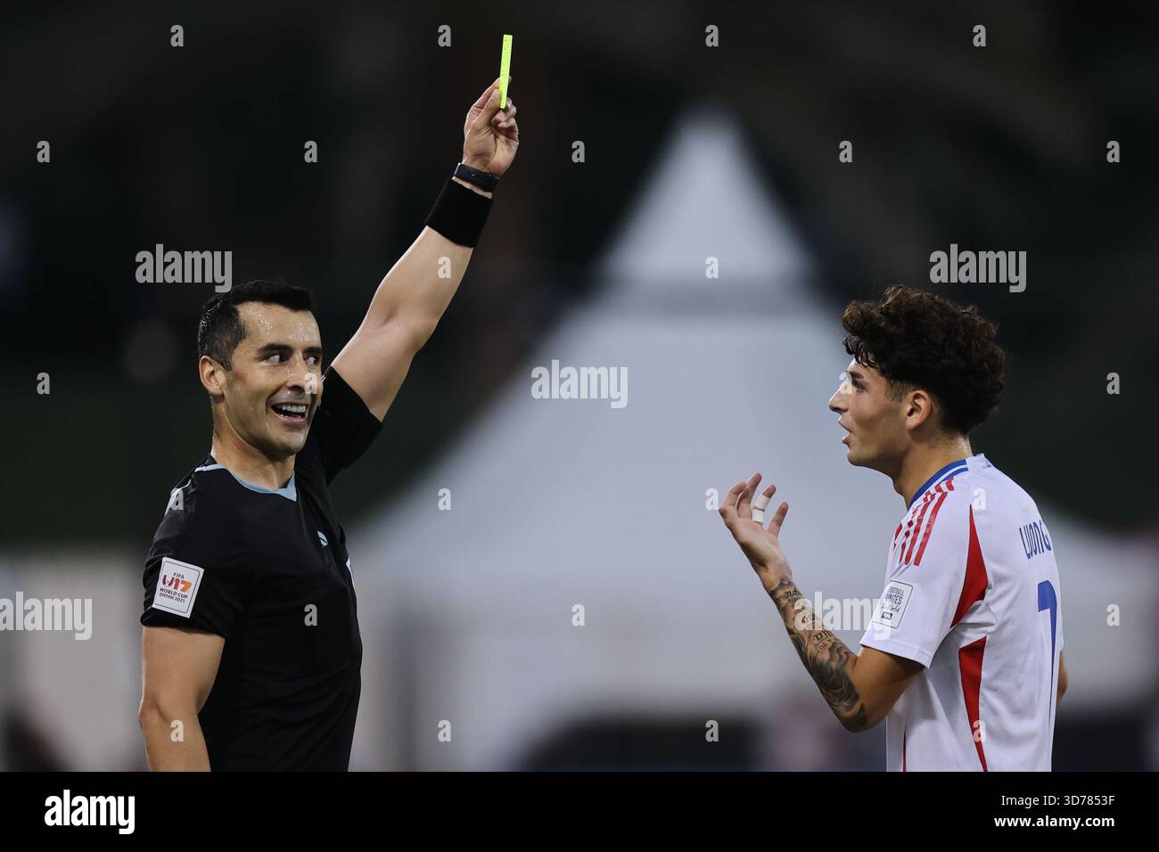 Italy's Andrea Luongo, right, receives a yellow card during the FIFA ...