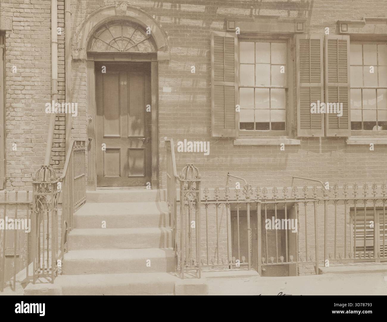 Brick row house entrance with a stoop and fence., 1895. New York City ...