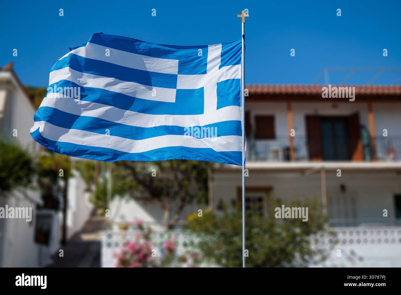 Greek flag waving in front of realestate Stock Photo - Alamy