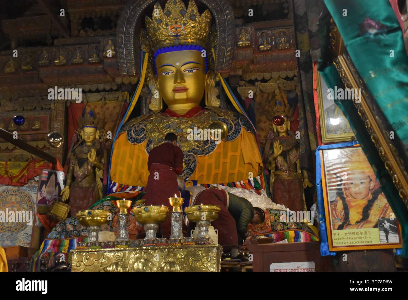 January 15th 2021 - Lhasa, Tibet: A Buddhist Monk in front of a statue ...