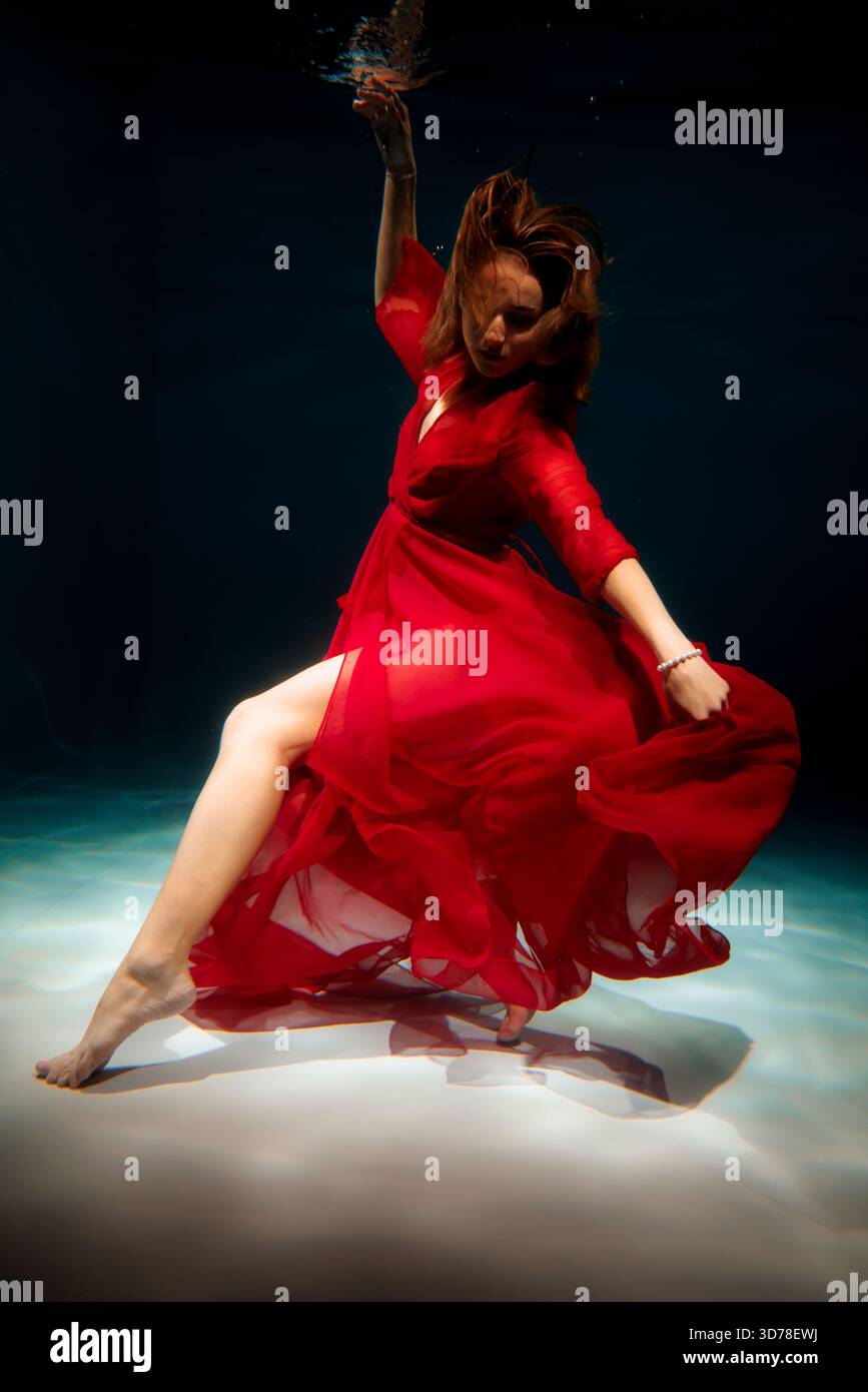 Underwater figure with flowing fabric creates mythic storytelling Stock ...
