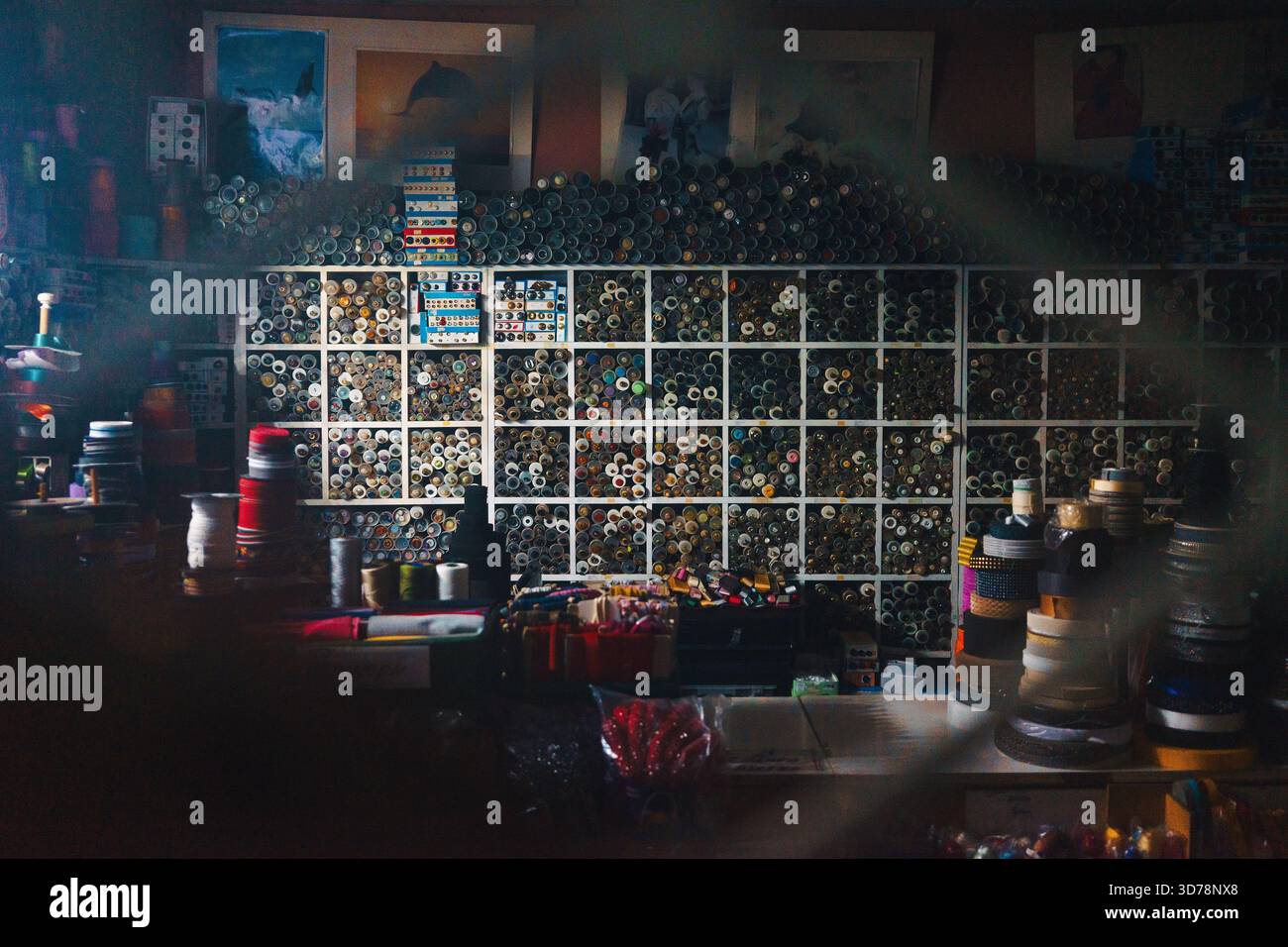 Interior of a store of various types of threads and buttons, night ...