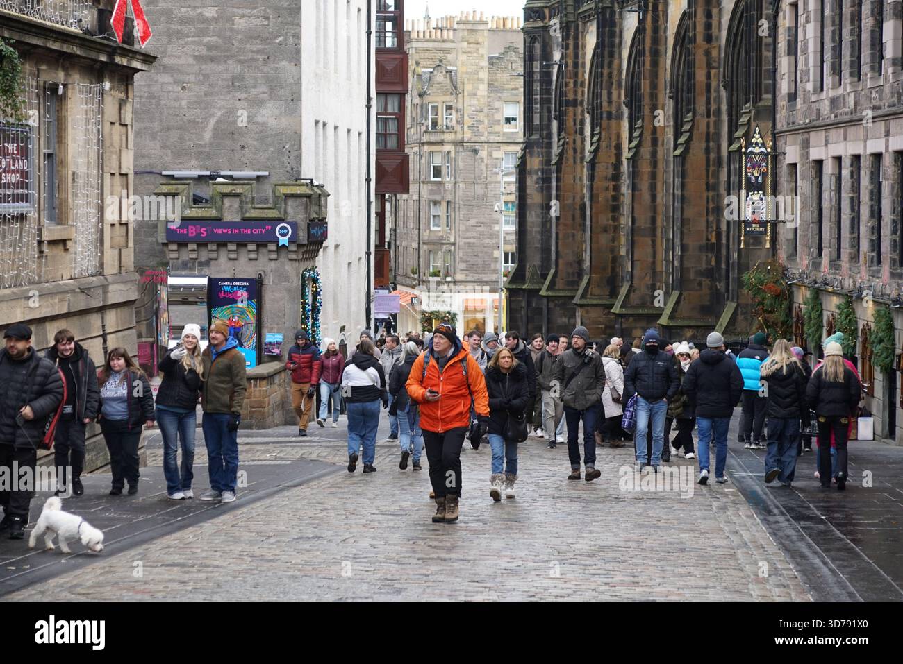 Busy street scene in Edinburgh’s Old Town, with pedestrians walking ...