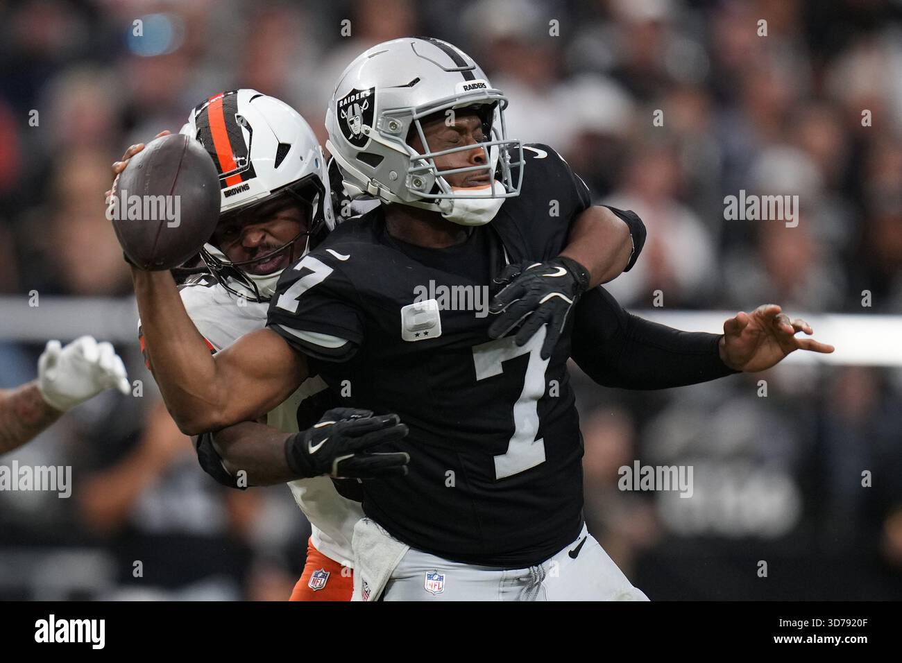 Las Vegas Raiders quarterback Geno Smith (7) is hit by Cleveland Browns ...