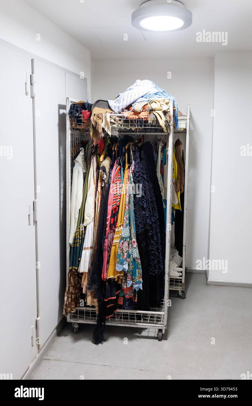 colorful collection of various garments and costumes on a clothing rack ...