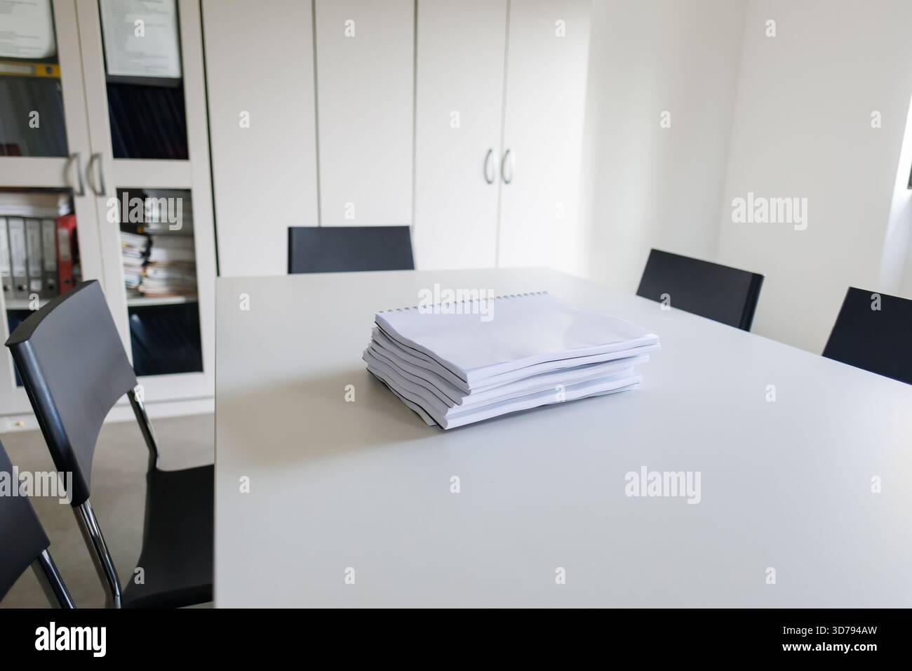 stacked documents on a conference table in a modern office Stock Photo ...