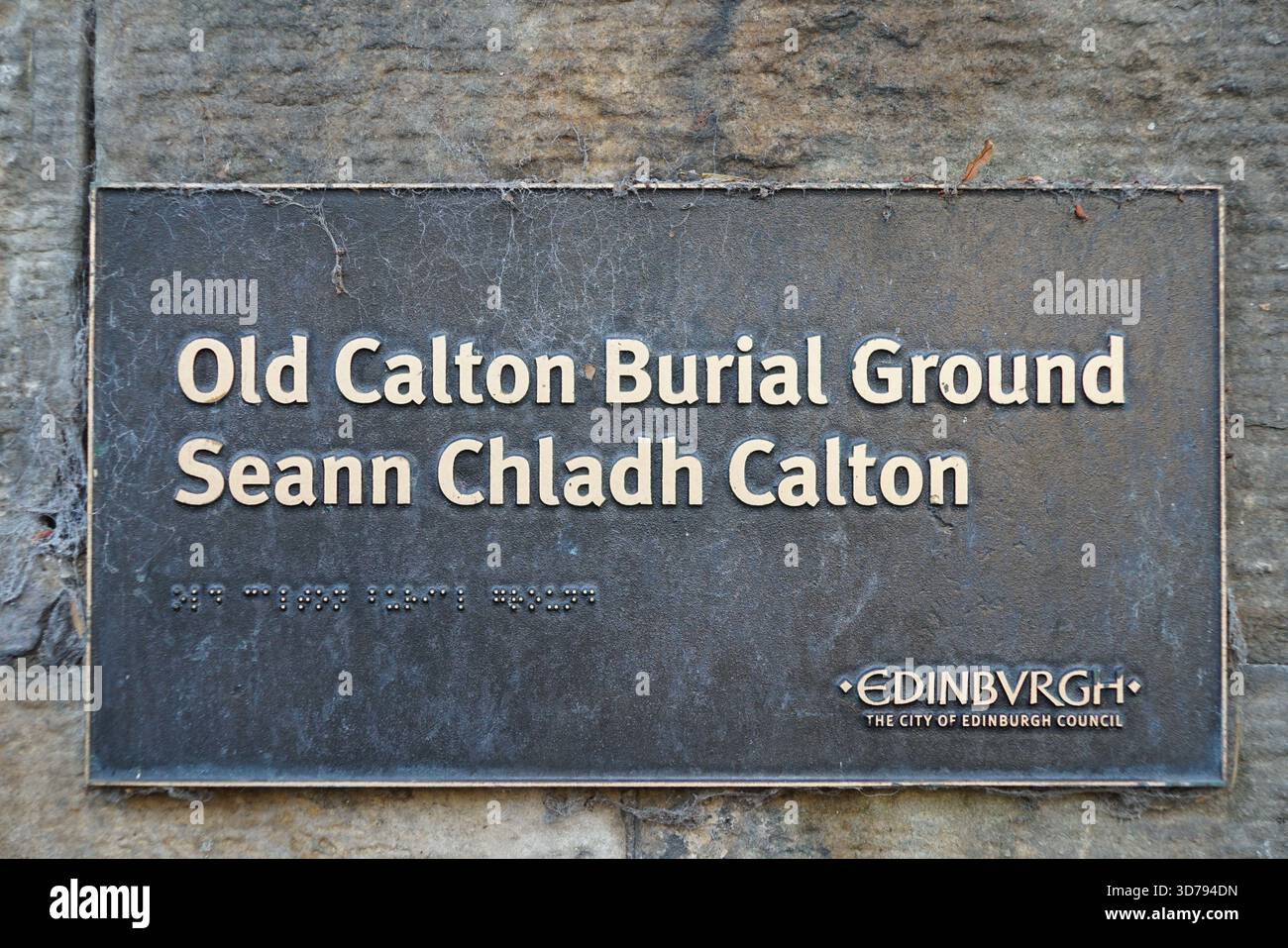 Plaque marking the Old Calton Burial Ground on a stone wall in ...