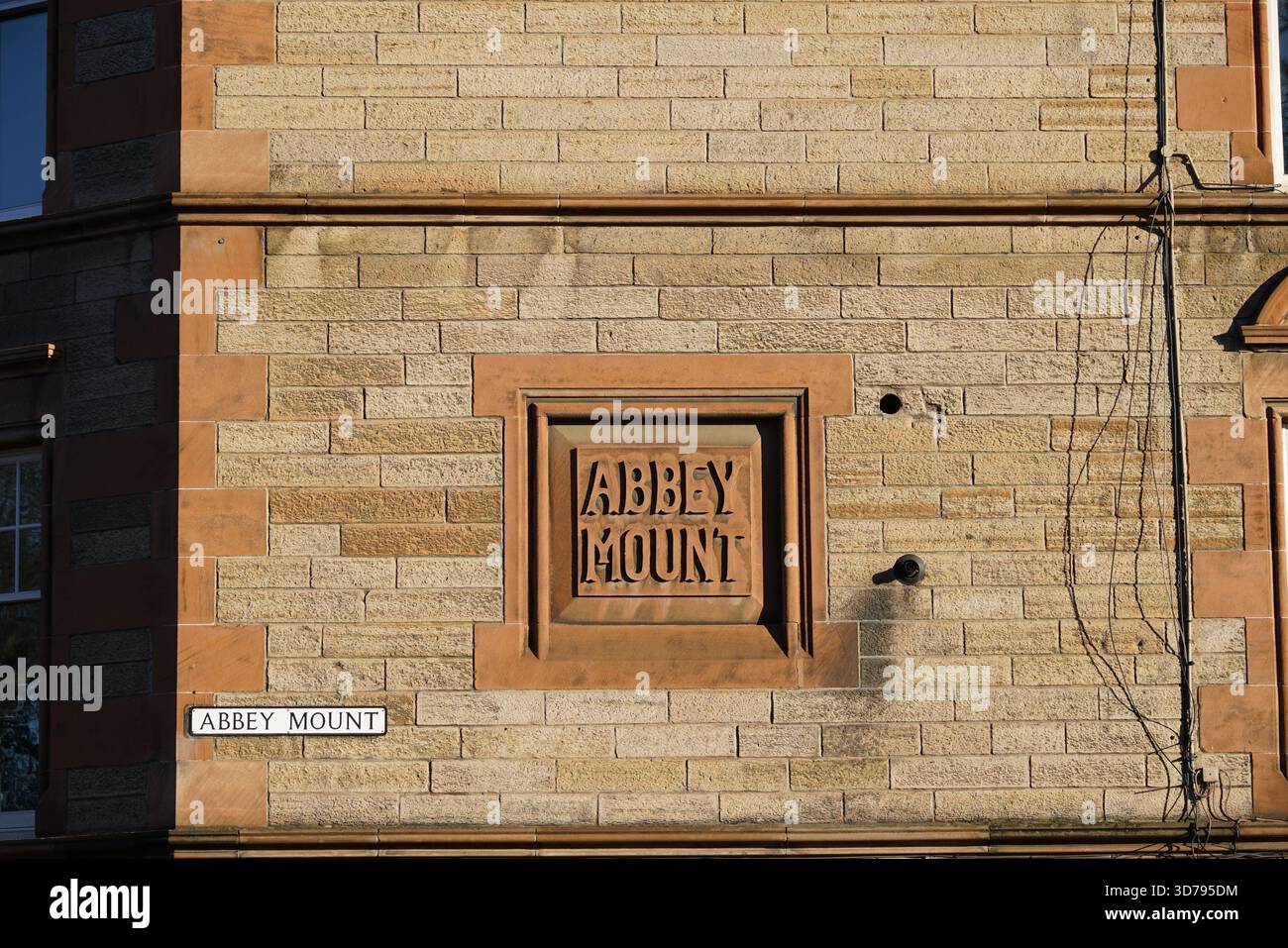 Abbey Mount carved stone wall sign on a historic sandstone building in ...