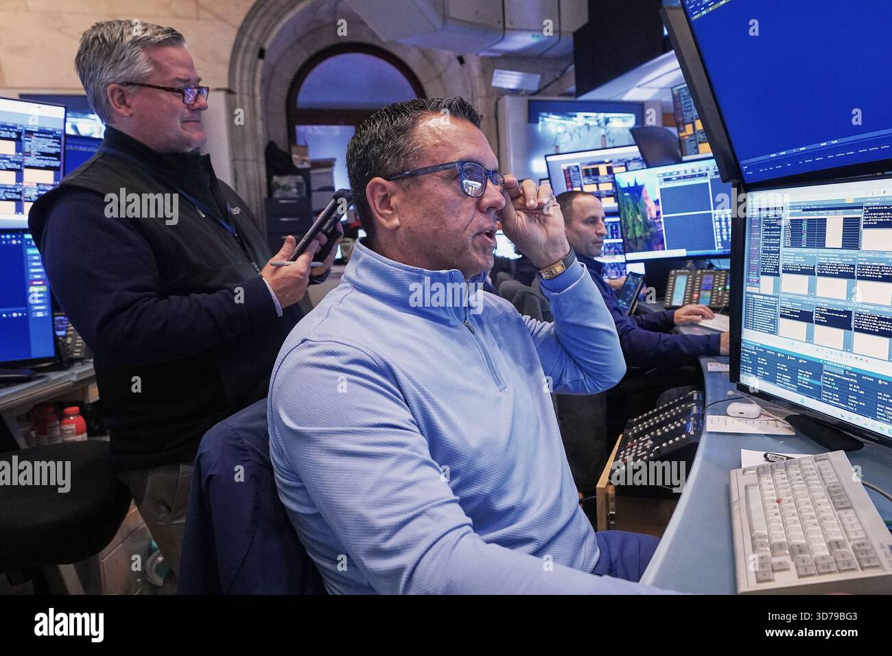 Trader Robert Finnerty Jr., right, works on the floor of the New York ...
