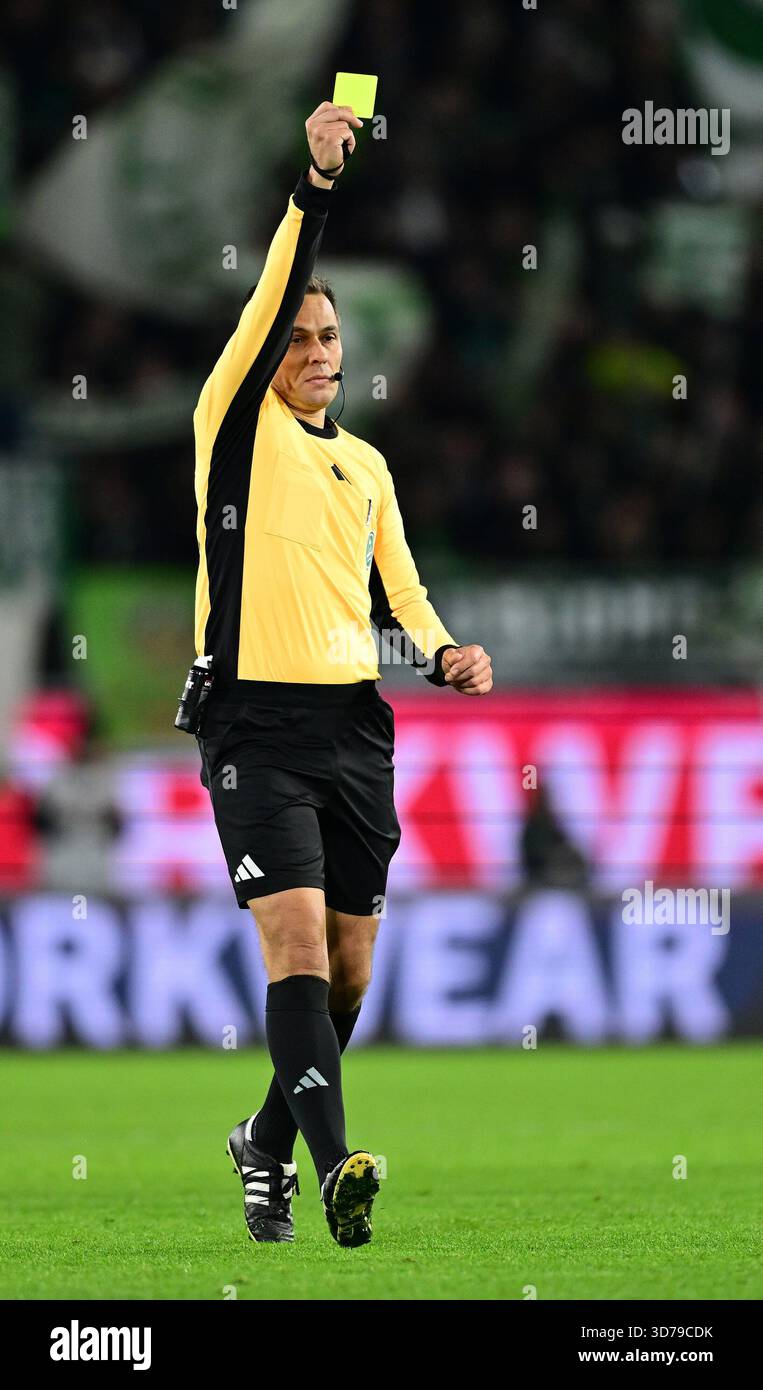 Referee Robert Hartmann shows the yellow card Wolfsburg, November 22 ...