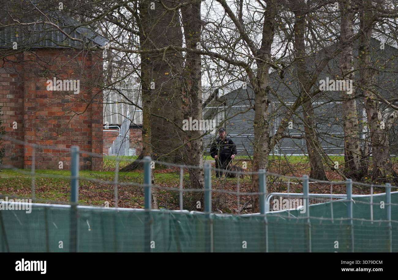 A security guard patrols Crowborough Training Camp, East Sussex. The ...
