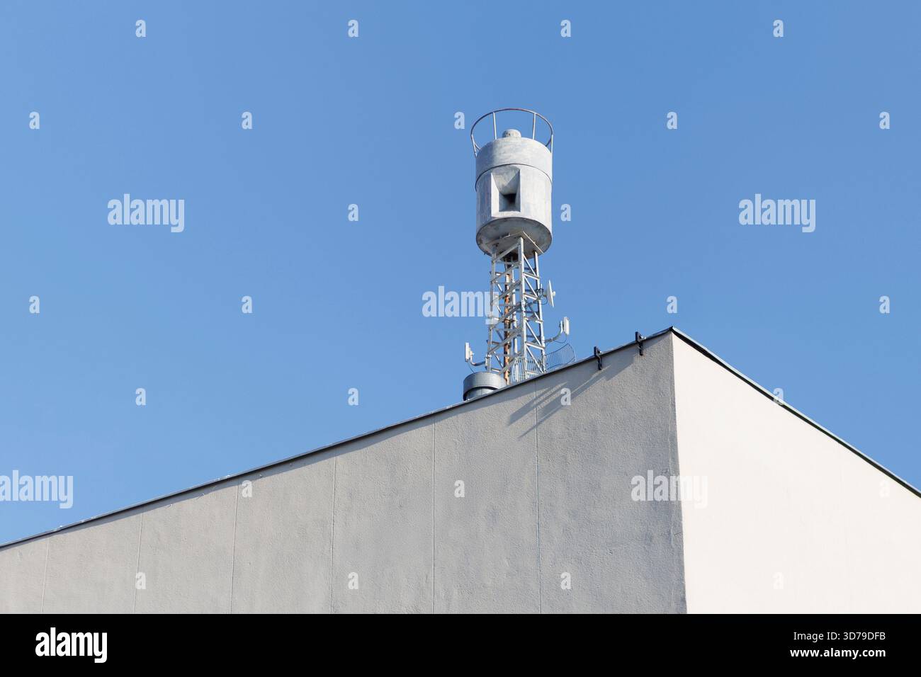 Water tower and communication antennas atop a modern building under ...